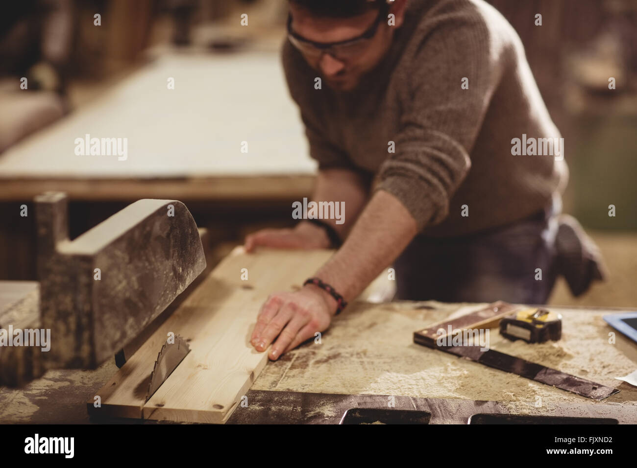 Happy carpenter working on his craft Stock Photo - Alamy