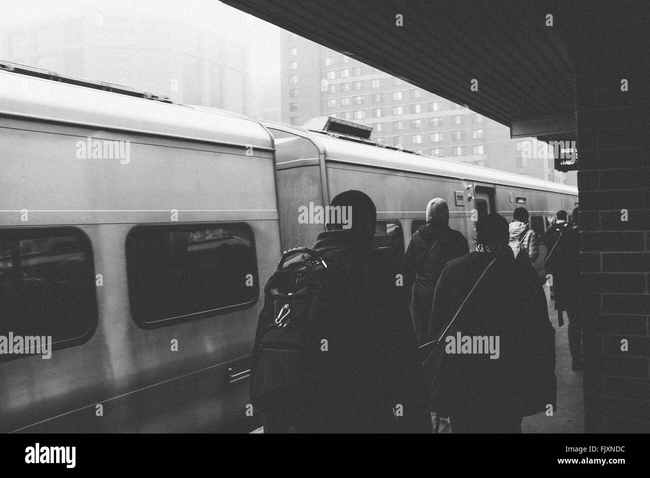 Rear View Of People By Train At Railroad Station Platform Stock Photo ...