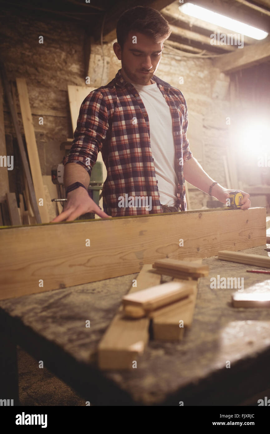 Happy carpenter working on his craft Stock Photo - Alamy