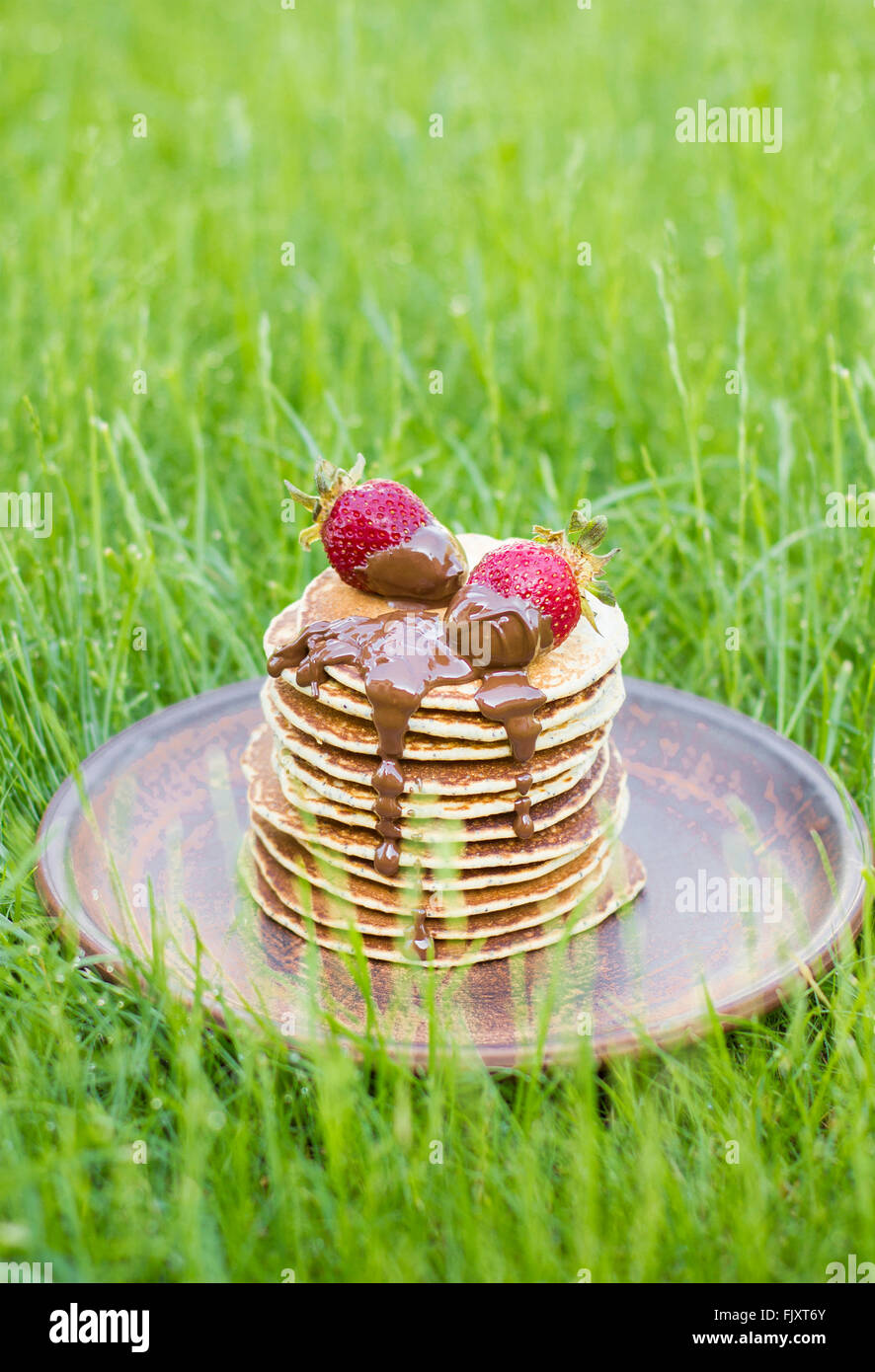 Strawberry pancakes for picnic on the grass vertical Stock Photo - Alamy