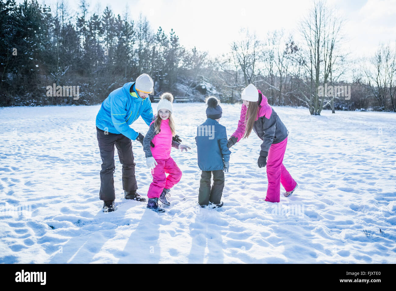 Family playing in the snow Stock Photo - Alamy