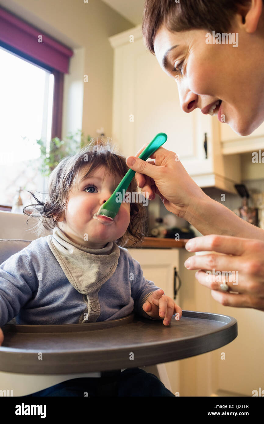 Cute mother feeding her baby Stock Photo - Alamy