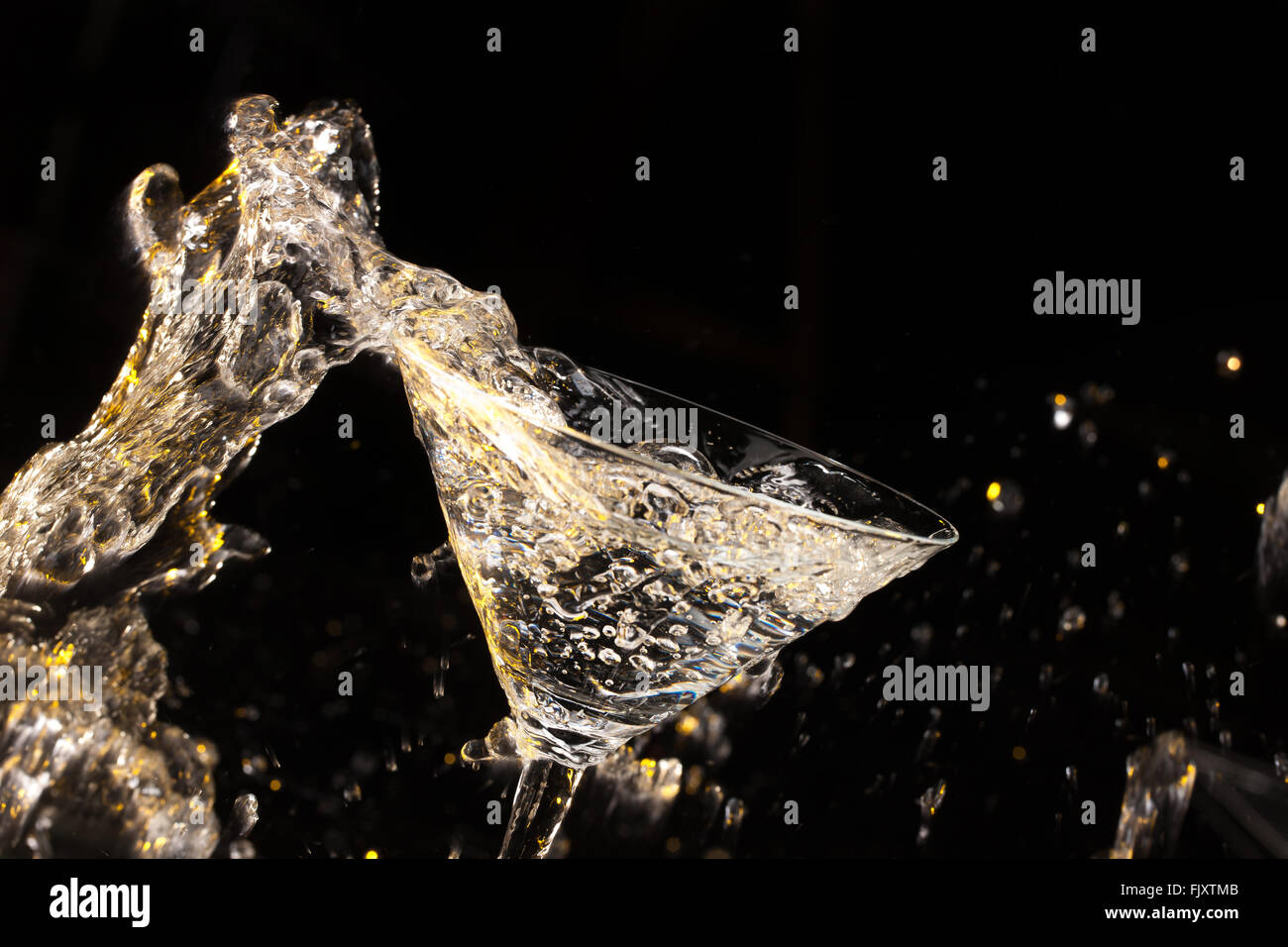 Liquid pouring in the glass on a black studio background Stock Photo ...