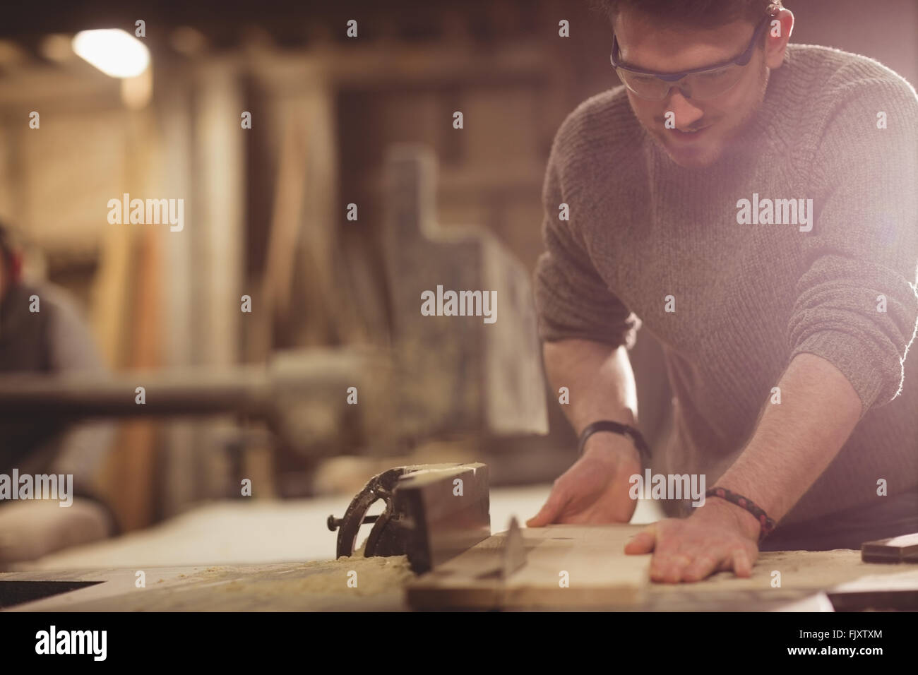 Happy carpenter working on his craft Stock Photo - Alamy