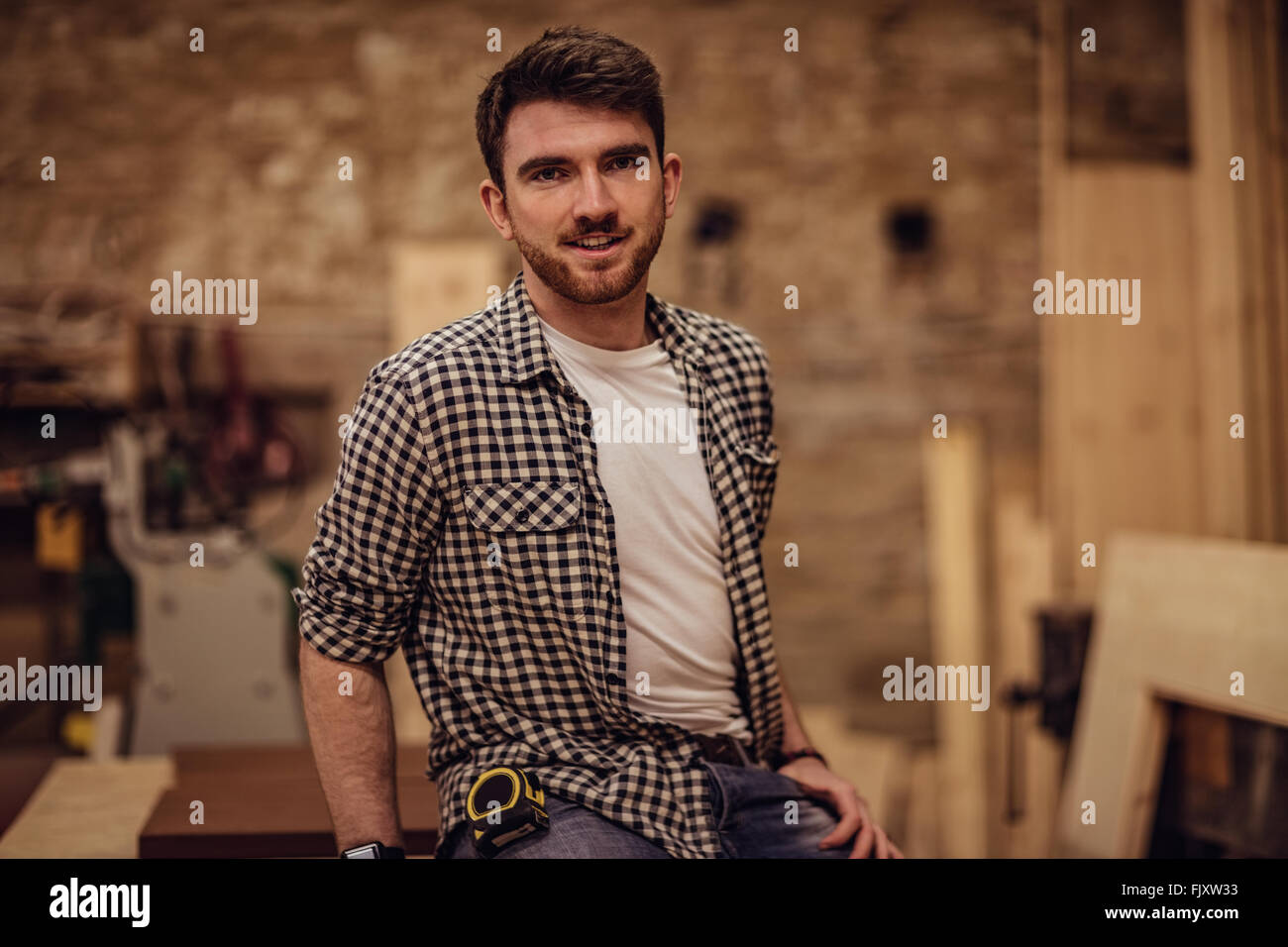 Carpenter smiling at the camera Stock Photo - Alamy