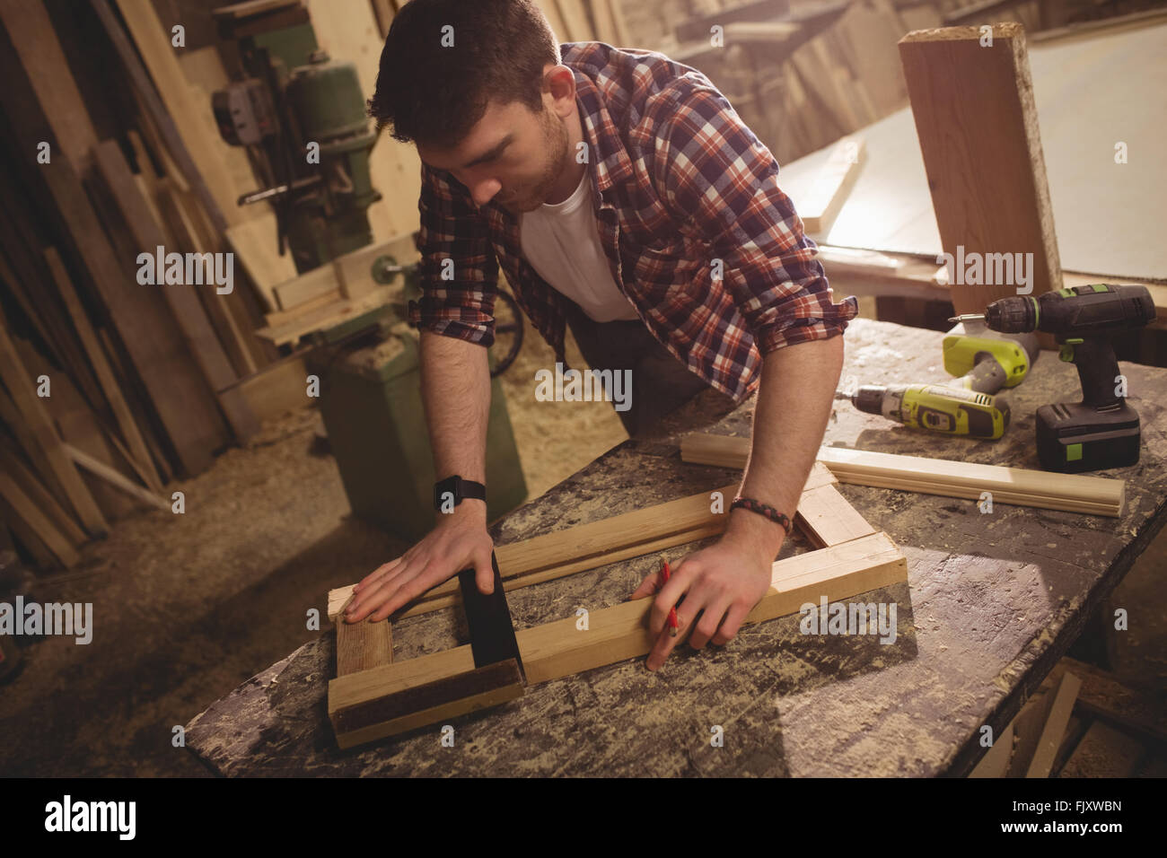 Happy carpenter working on his craft Stock Photo - Alamy