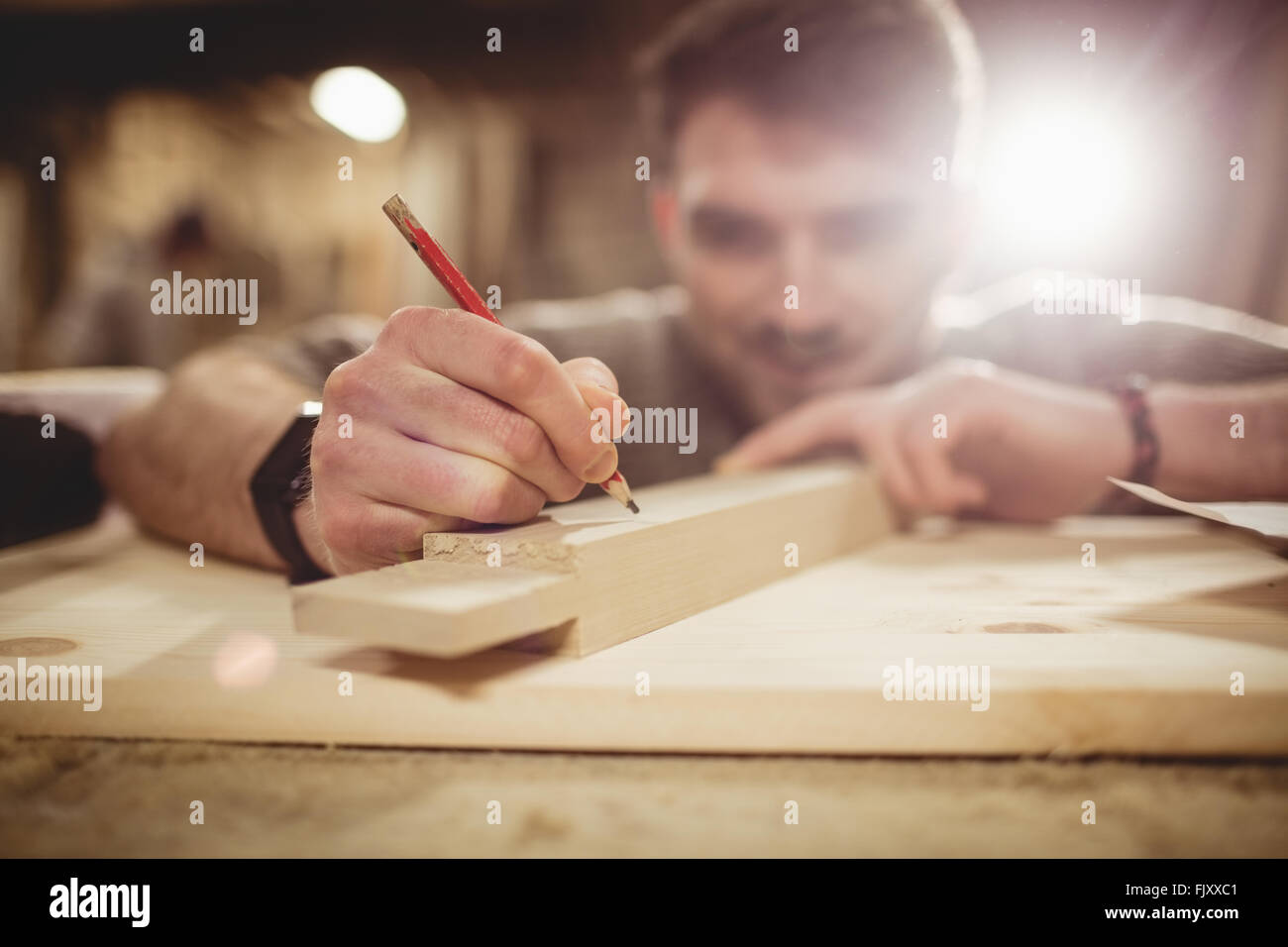 Happy carpenter working on his craft Stock Photo - Alamy