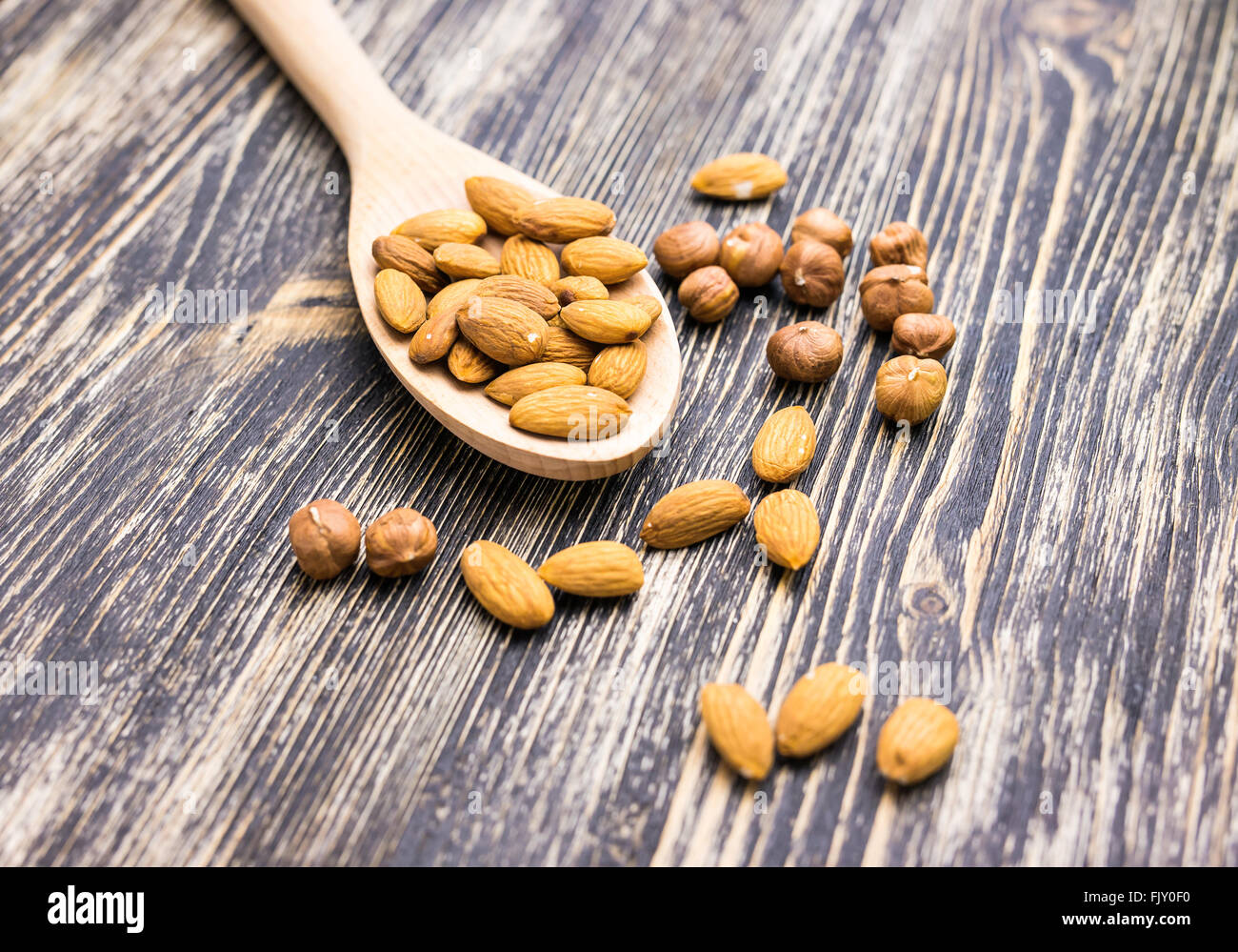 Almonds on wooden background Stock Photo - Alamy