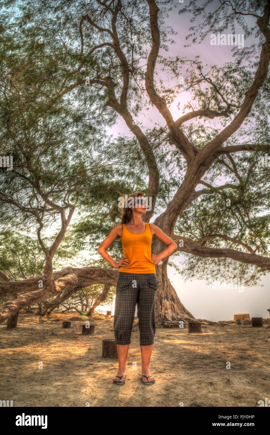 Woman Standing Against Tree Stock Photo - Alamy