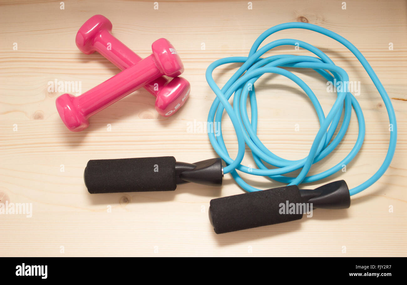 Blue skipping rope and pink weight Stock Photo - Alamy
