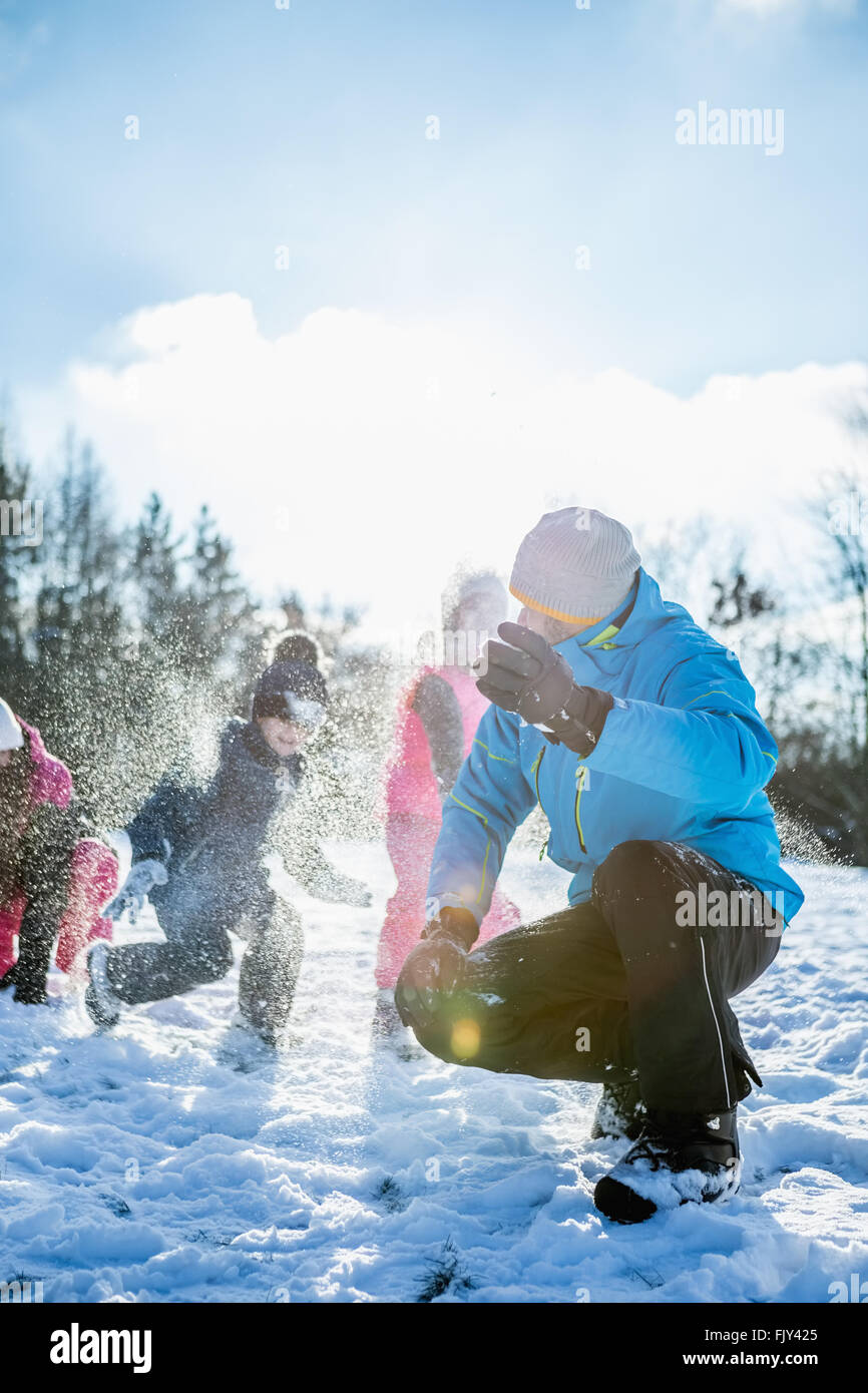 Family playing snowball fight Stock Photo - Alamy