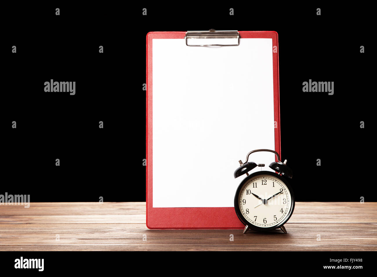 Blank paper sheet and alarm clock Stock Photo - Alamy