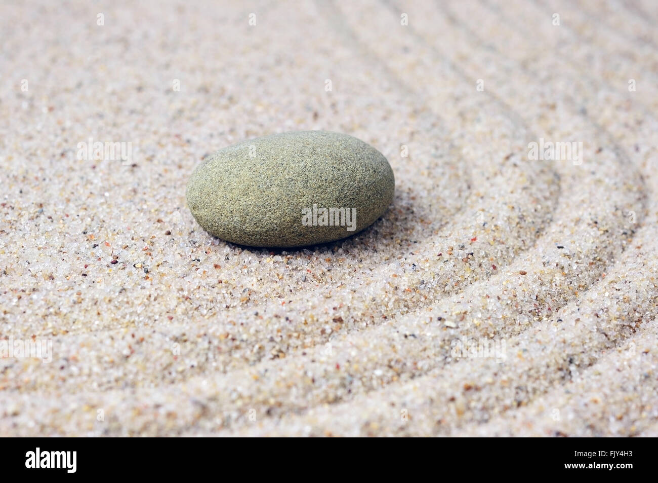 Zen stones on a raked sand for meditation spa, massage, wellness ...
