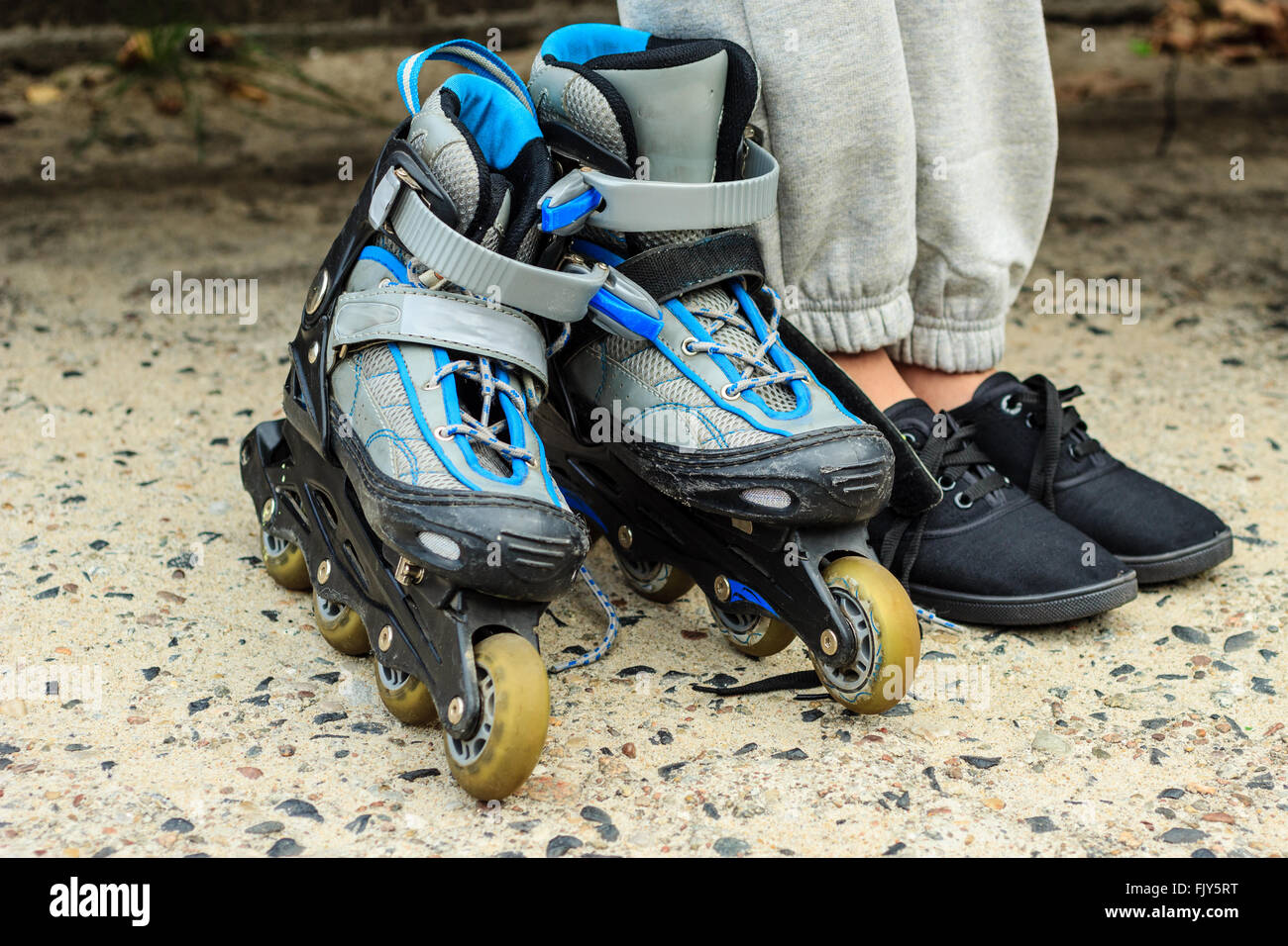 Closeup of woman girl with roller skates blades outdoor Stock Photo - Alamy