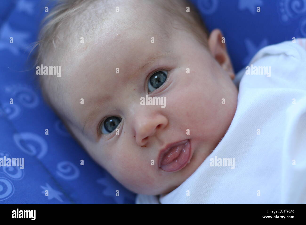 Blue eyed baby girl chilling Stock Photo - Alamy
