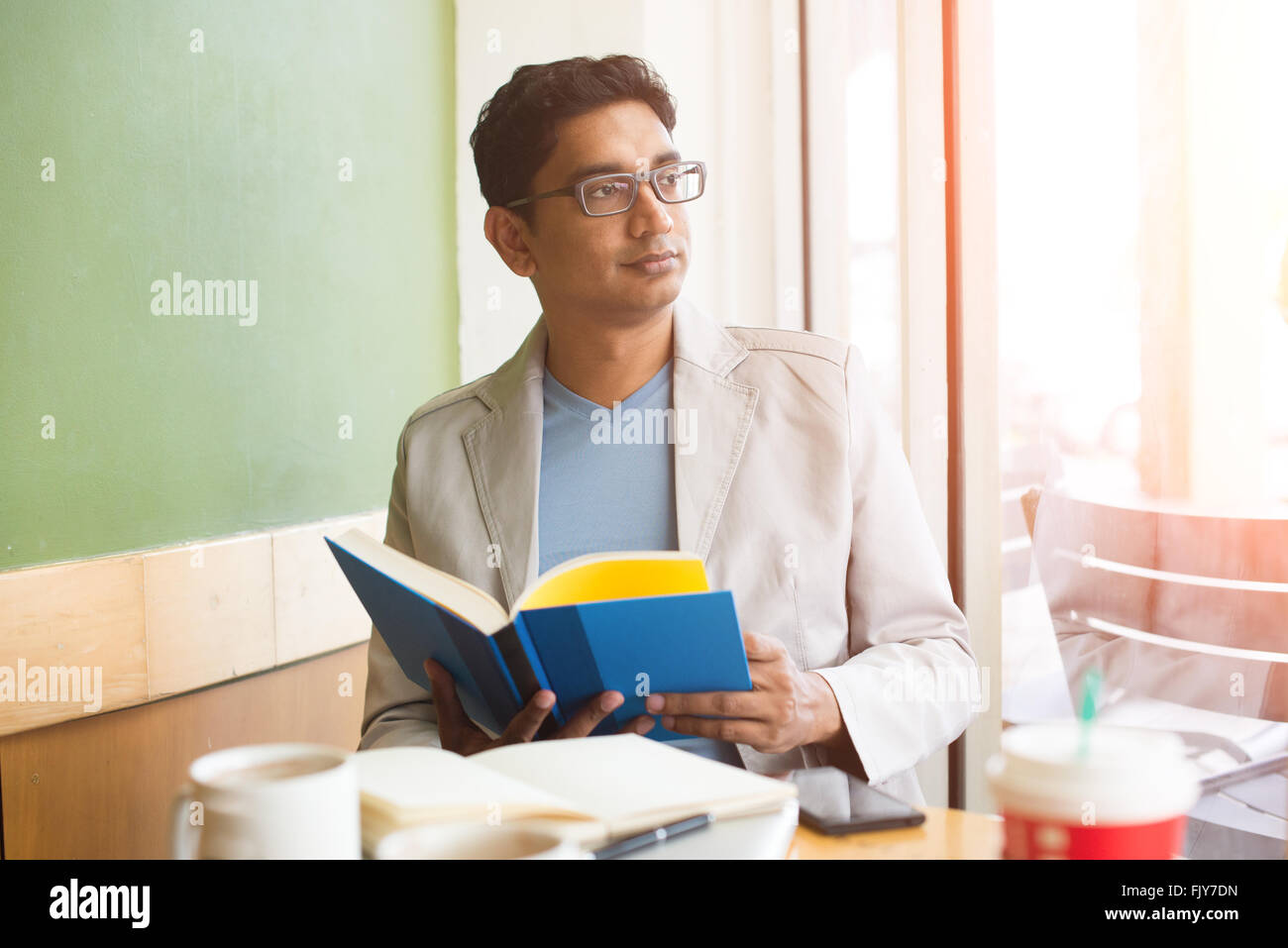 Attractive indian man read hi-res stock photography and images - Alamy