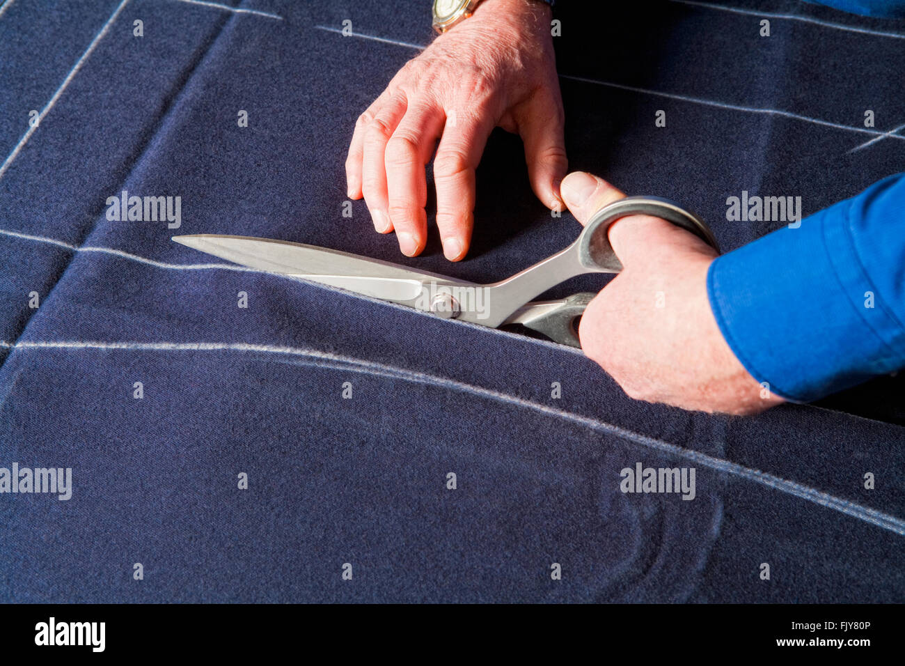 Tailor cutting cloth hi-res stock photography and images - Alamy