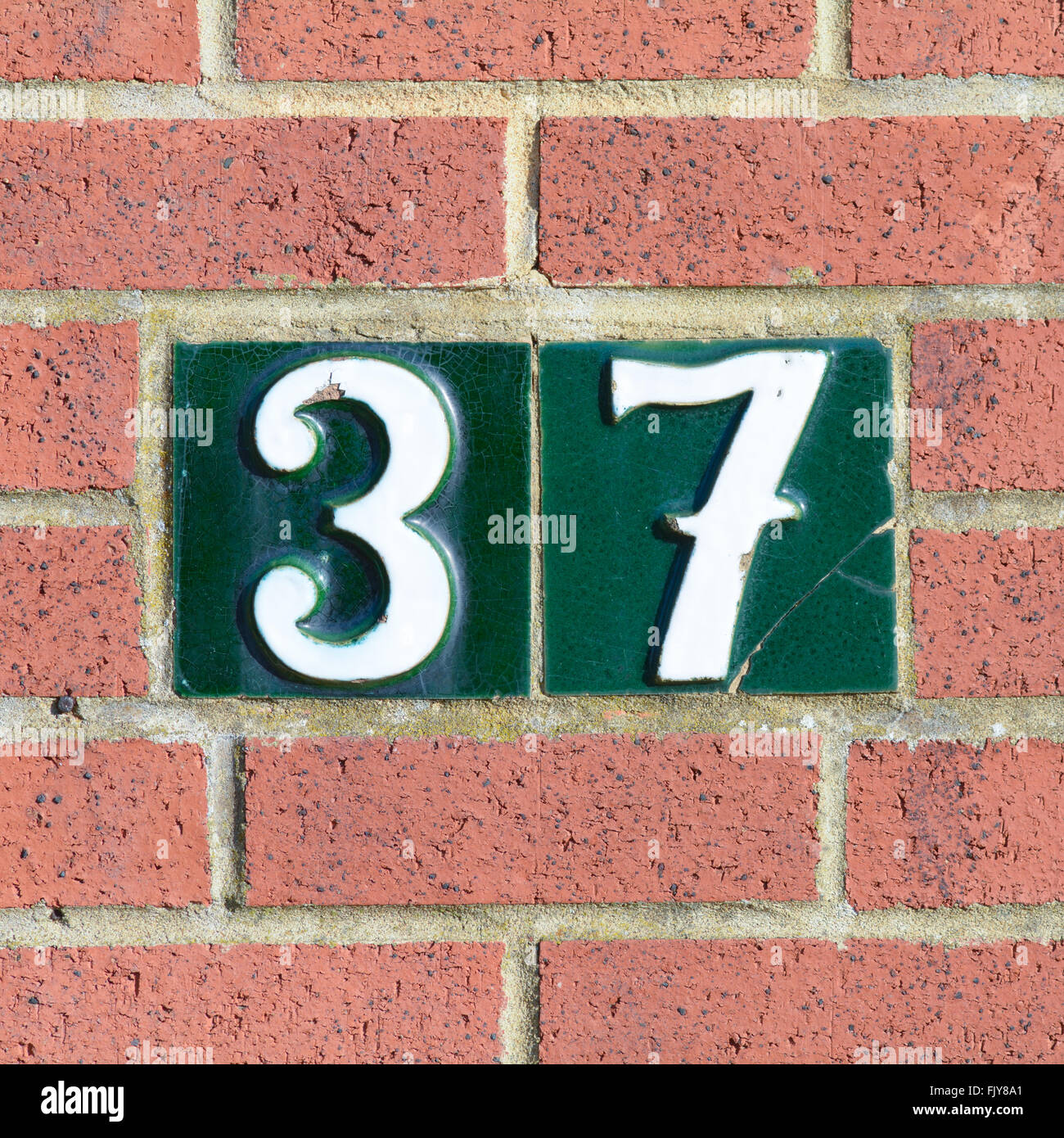 House number 37 sign on wall Stock Photo - Alamy