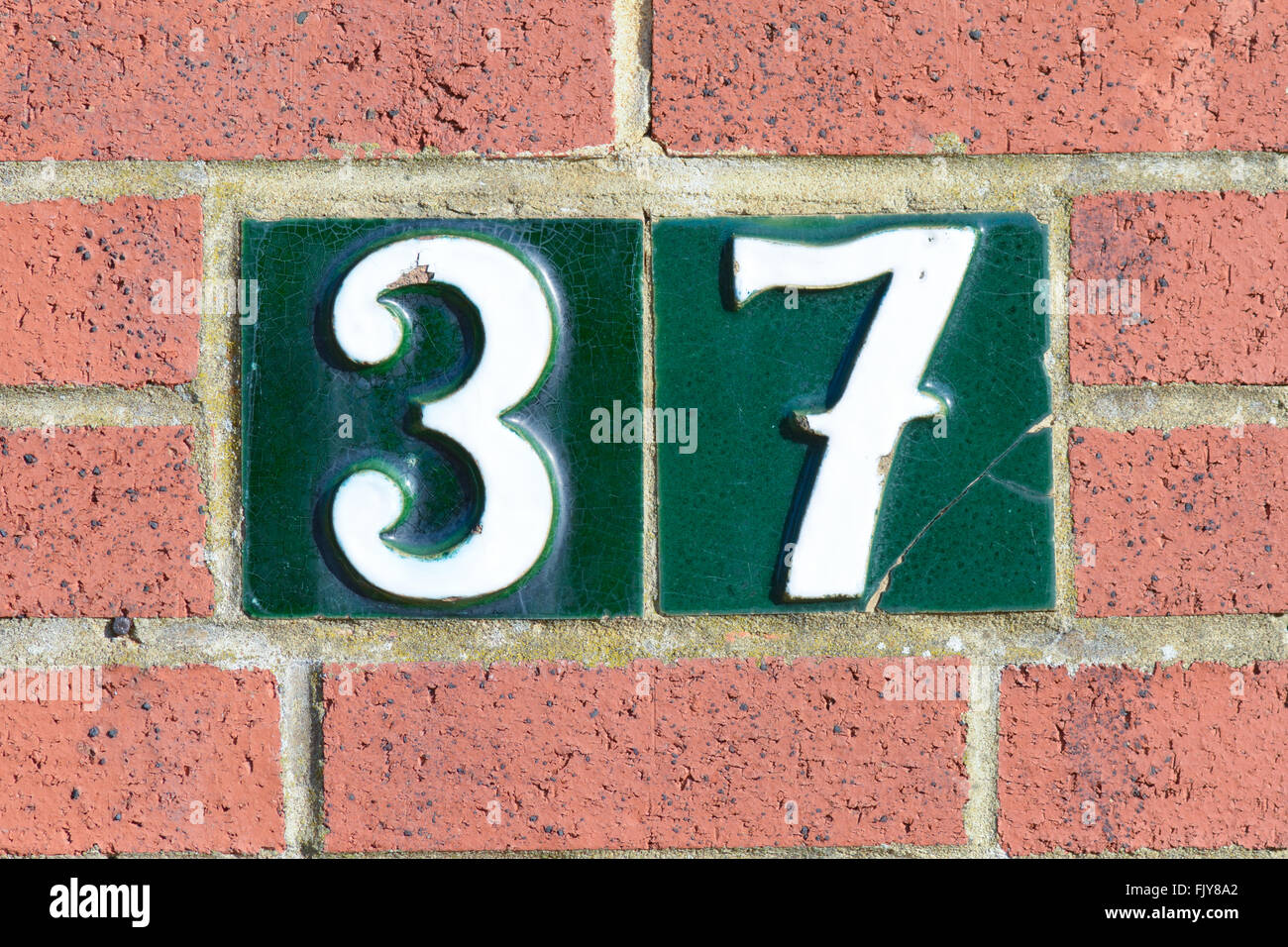 House number 37 sign on wall Stock Photo - Alamy