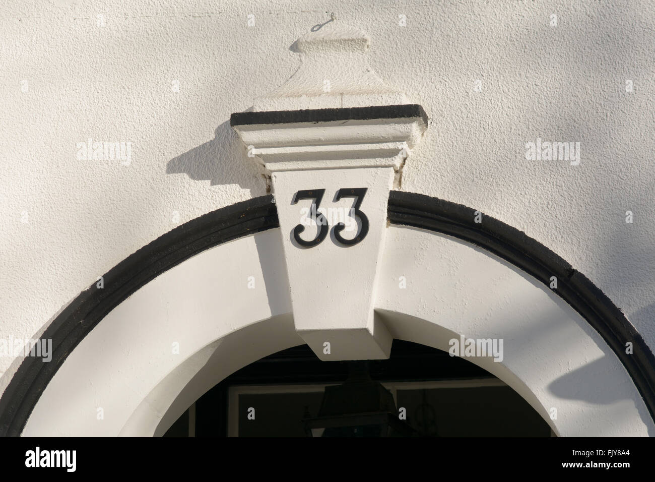 House number 33 sign above doorway Stock Photo - Alamy