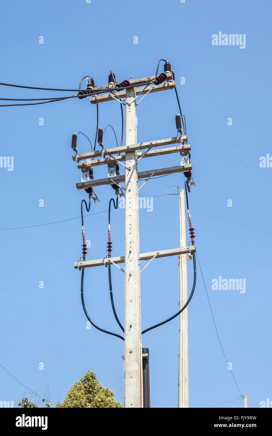 electricity post on blue sky background Stock Photo - Alamy
