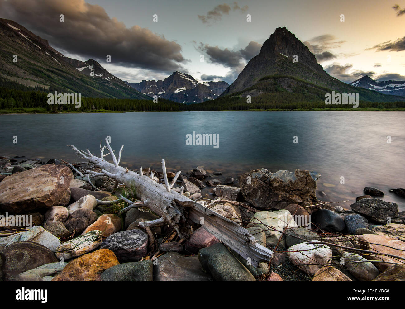 Colorful sunset over Swiftcurrent Lake in Glacier National Park ...