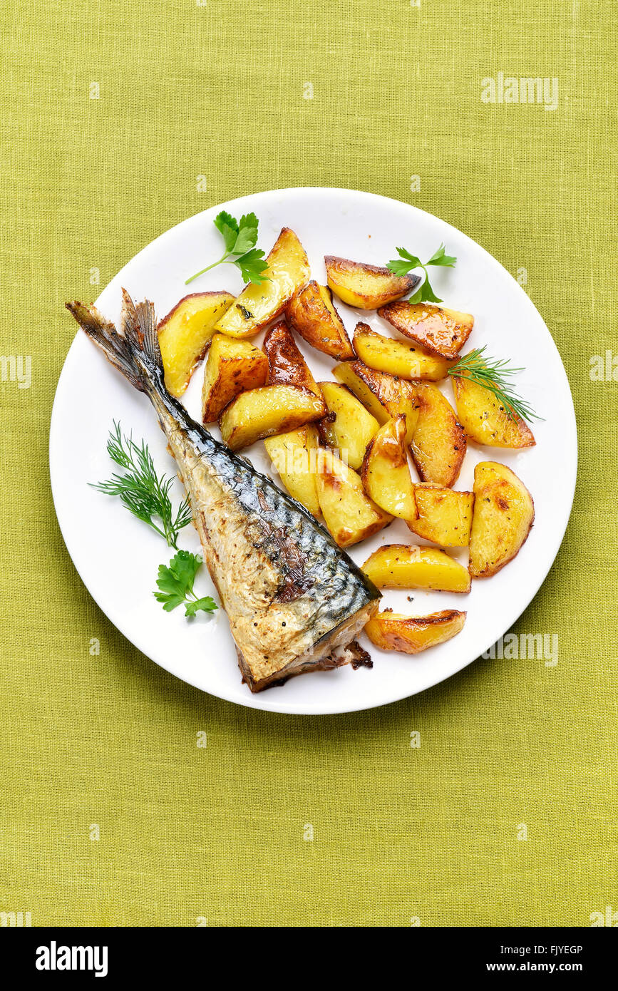 Roasted fish with baked potato wedges hi-res stock photography and ...
