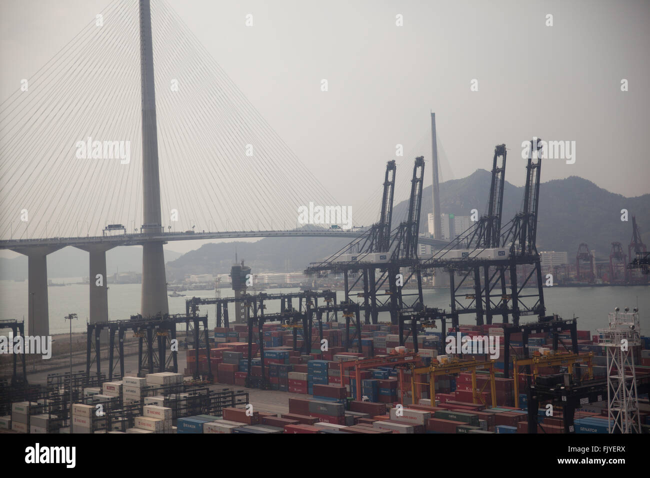 Bridge By Containers And Cranes Against Clear Sky Stock Photo - Alamy