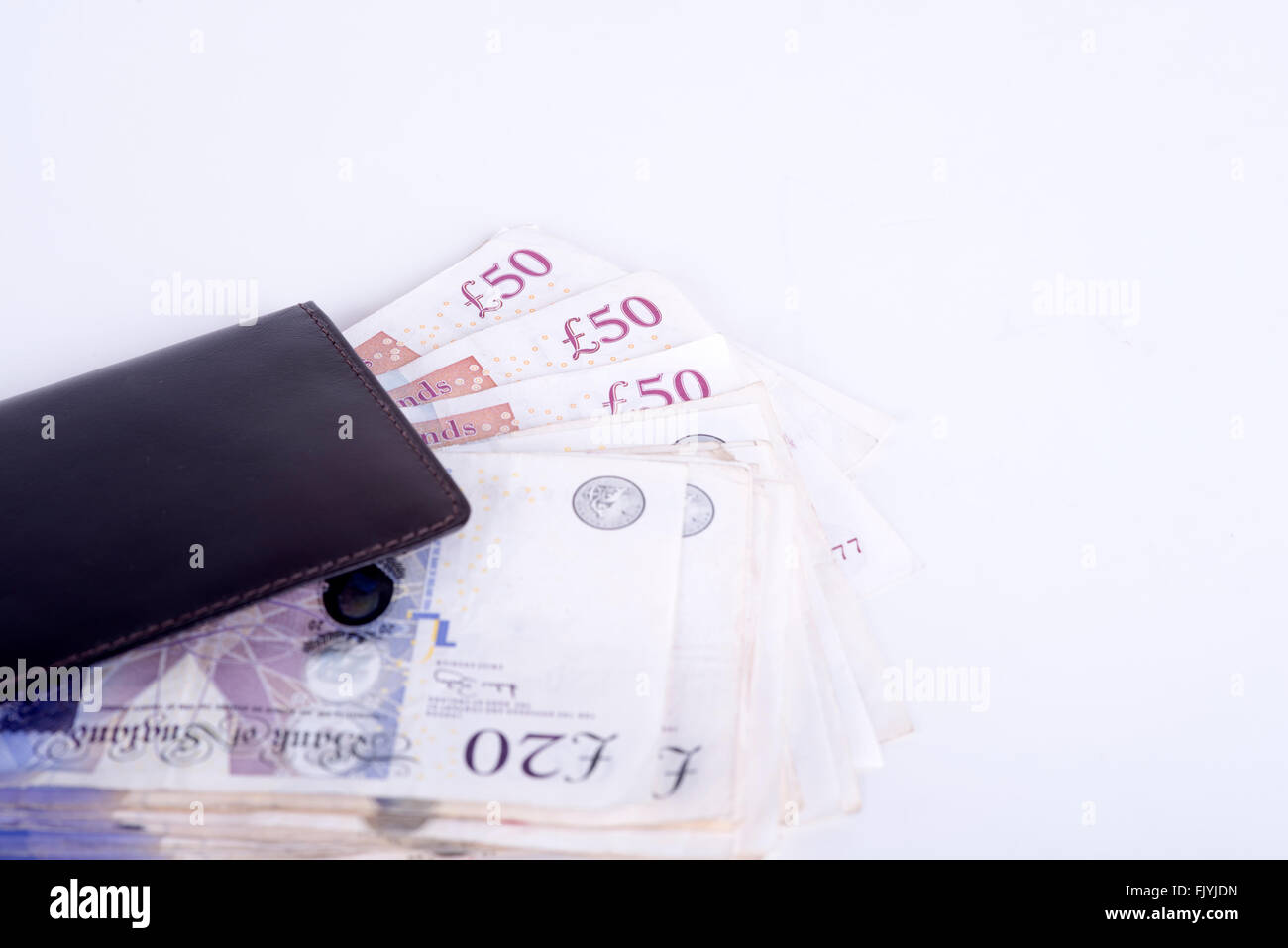 picture wallet full of pounds on a white background Stock Photo - Alamy