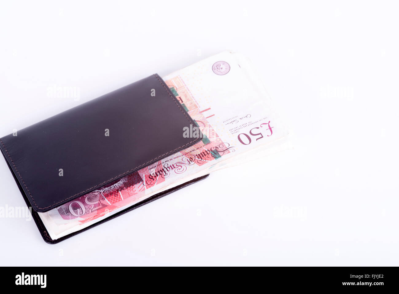 picture wallet full of pounds on a white background Stock Photo - Alamy