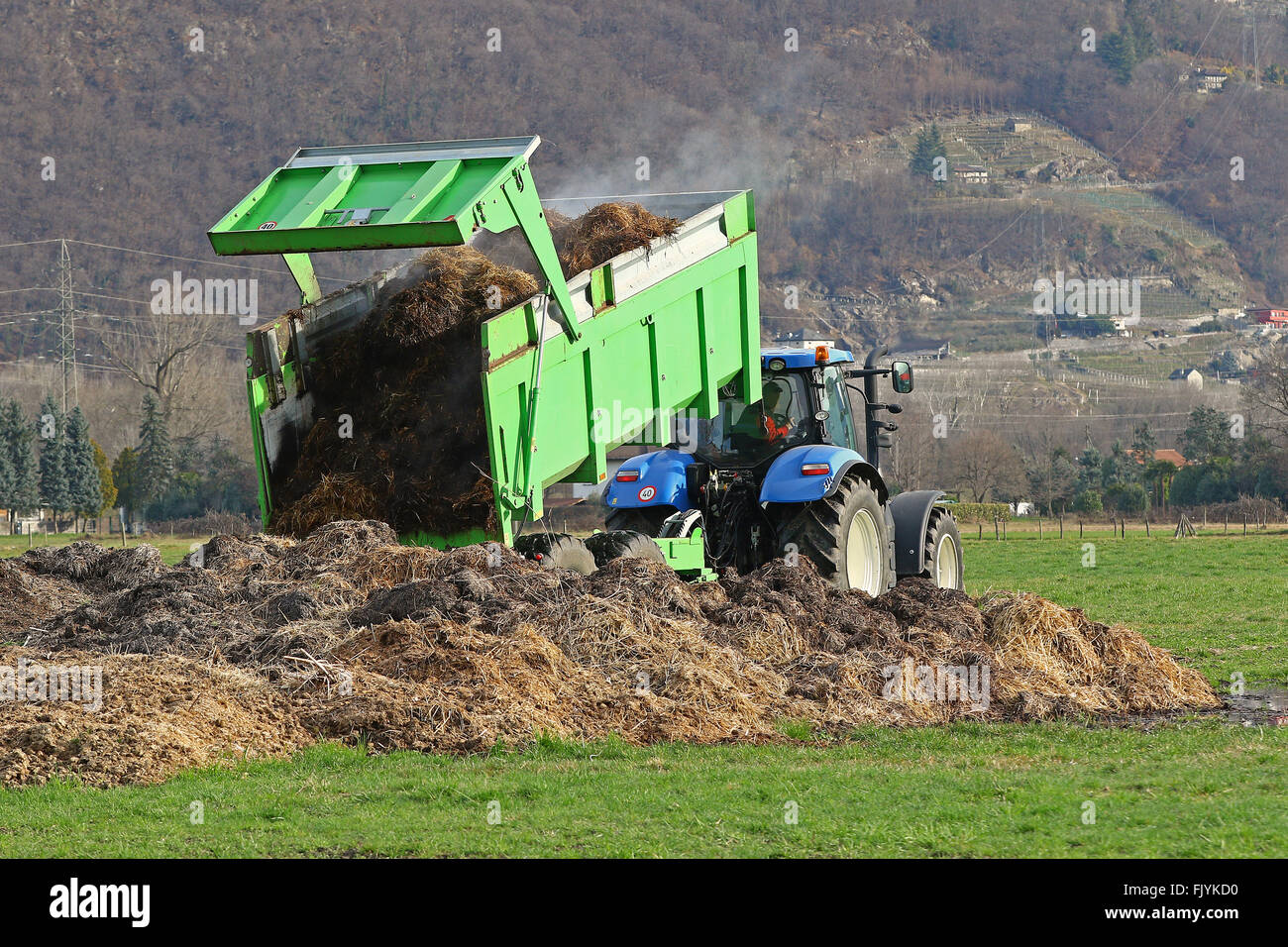 Tractor with trailer dumping manure Stock Photo - Alamy