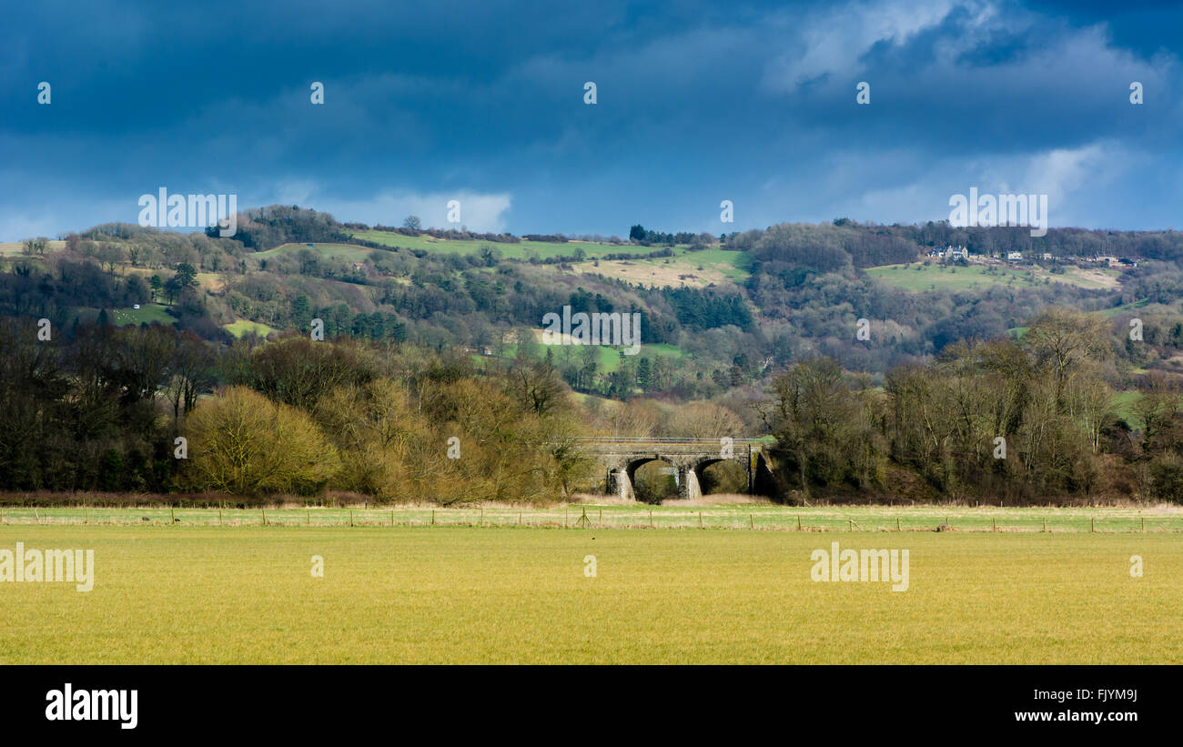 View of railway bridge in English countryside. Part of the River Avon ...
