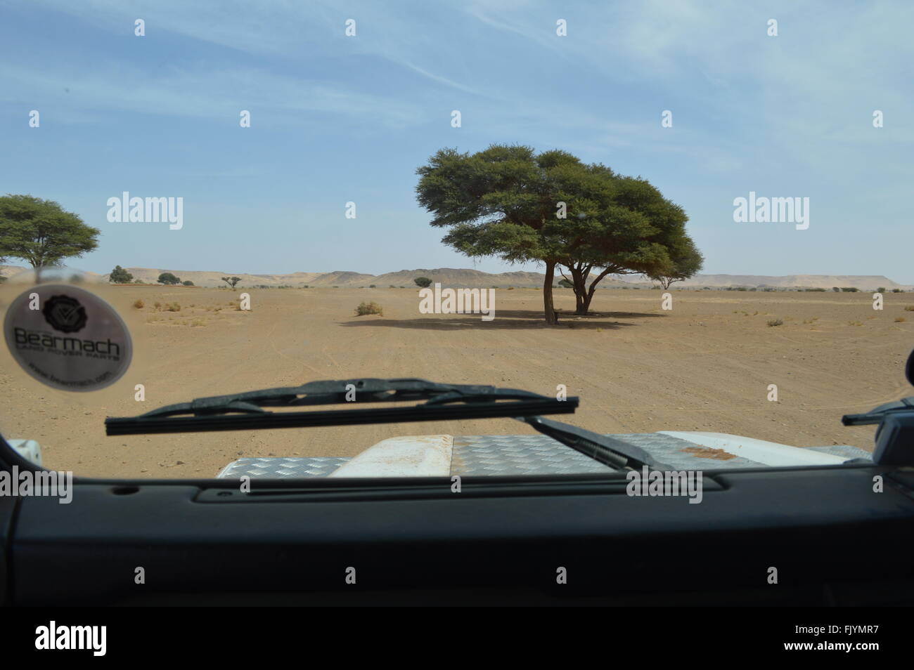 Driving Land Rover Defender in Sahara Stock Photo - Alamy