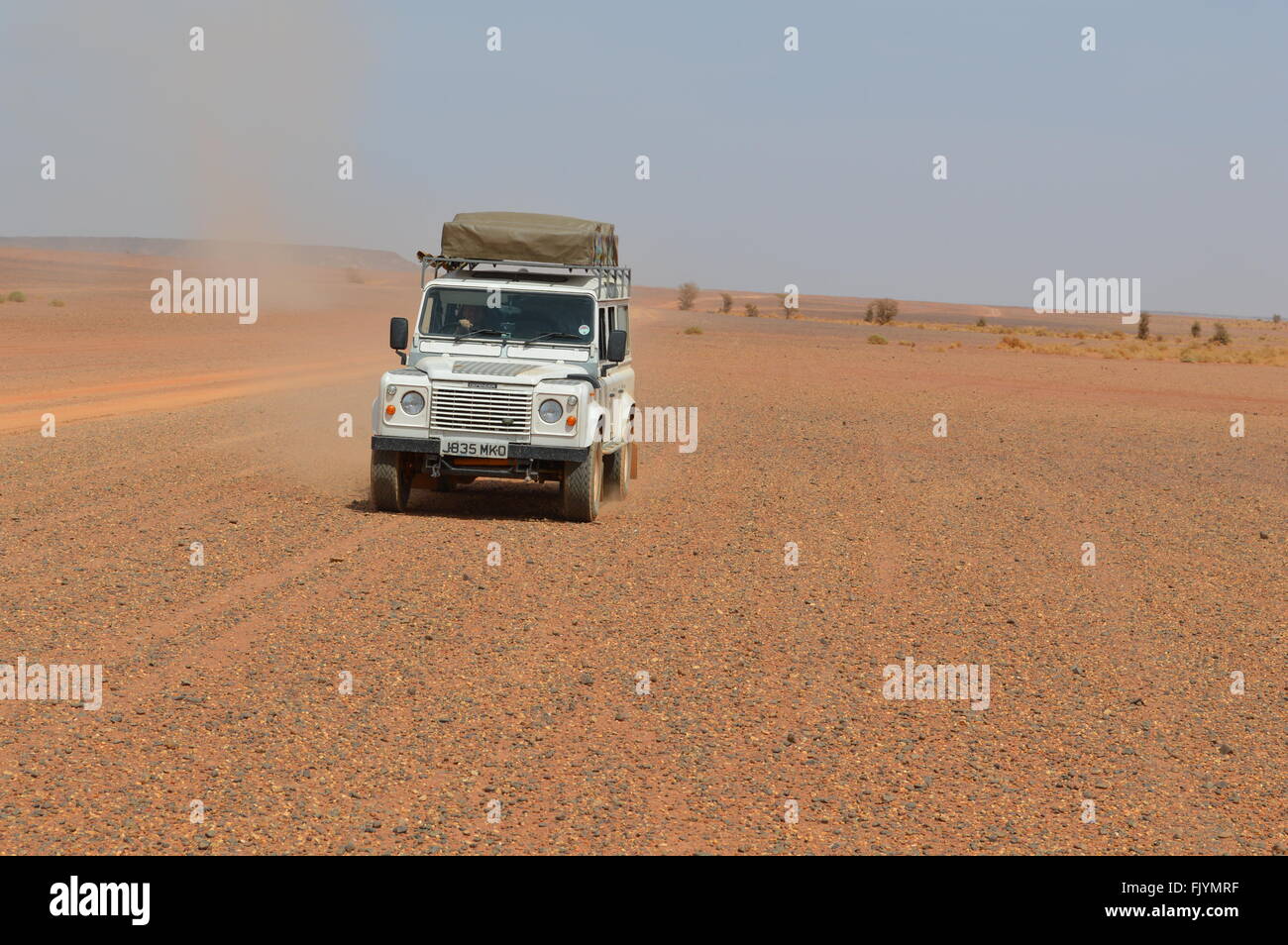 Driving Land Rover Defender in Sahara Stock Photo - Alamy