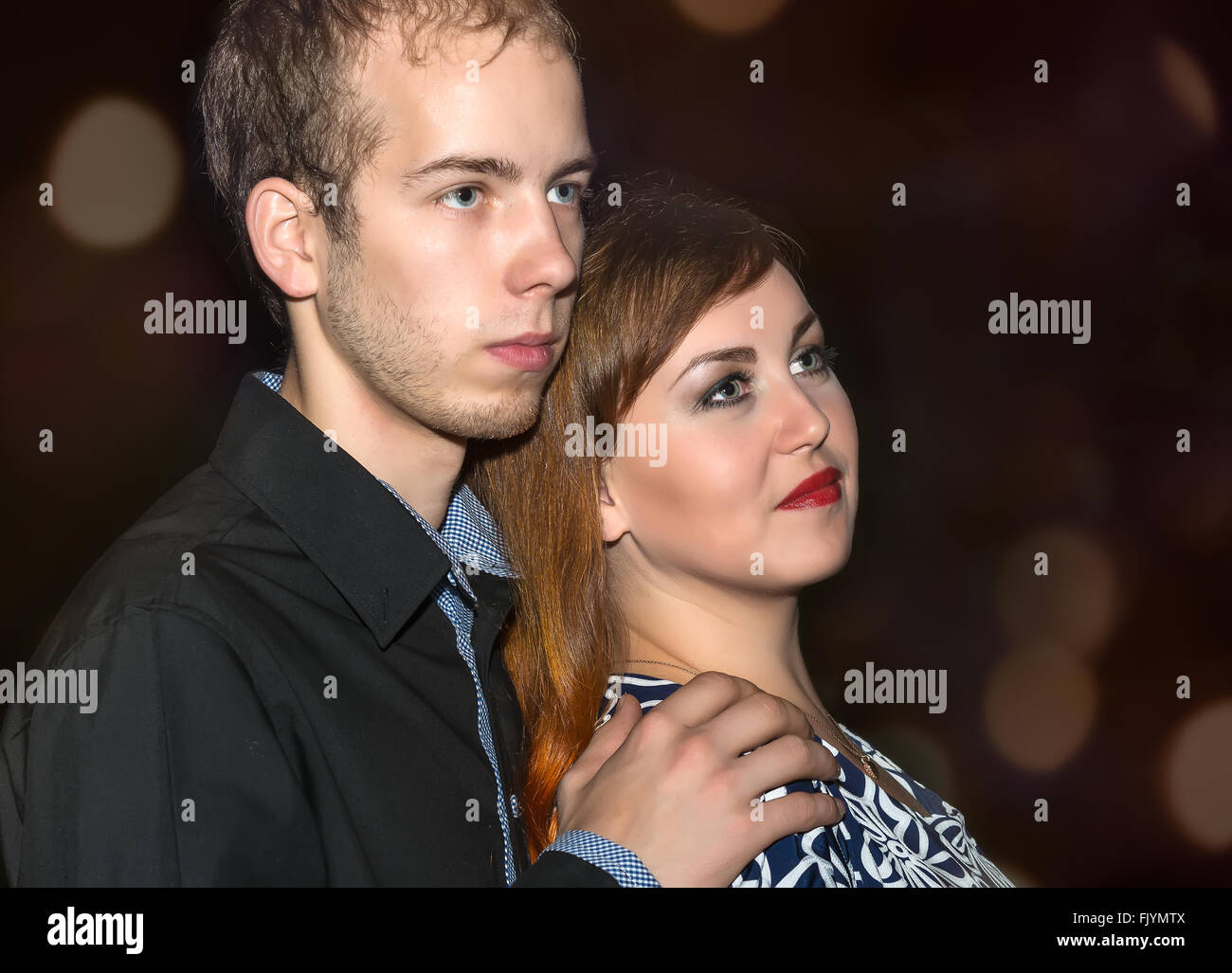 Portrait of couple looking in one direction on abstract background ...