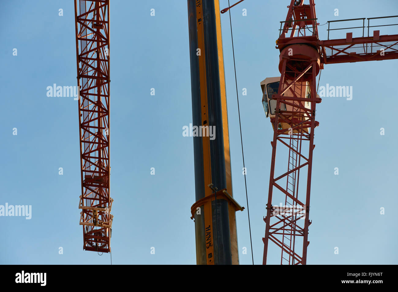 Construction worker dismantling tower crane Stock Photo - Alamy