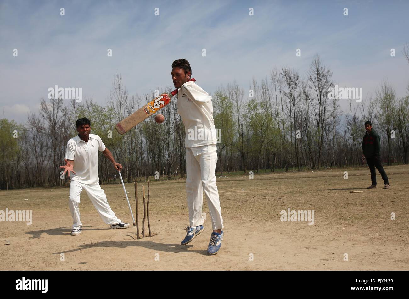 Srinagar, Kashmir. 4th March, 2016. Amir Hussain Lone (C) tries to hit ...