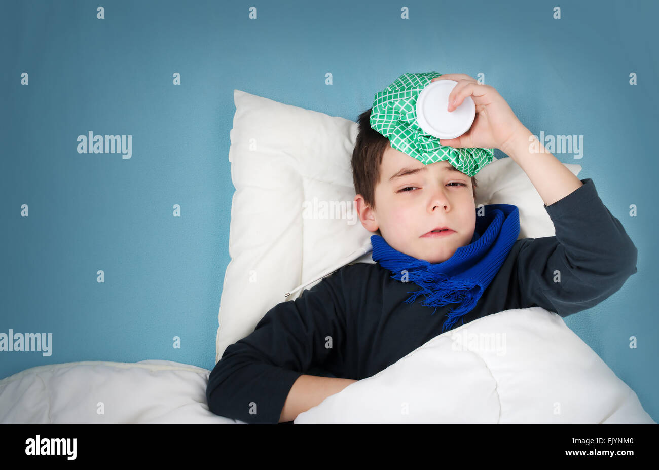 Ill boy lying in bed Stock Photo - Alamy