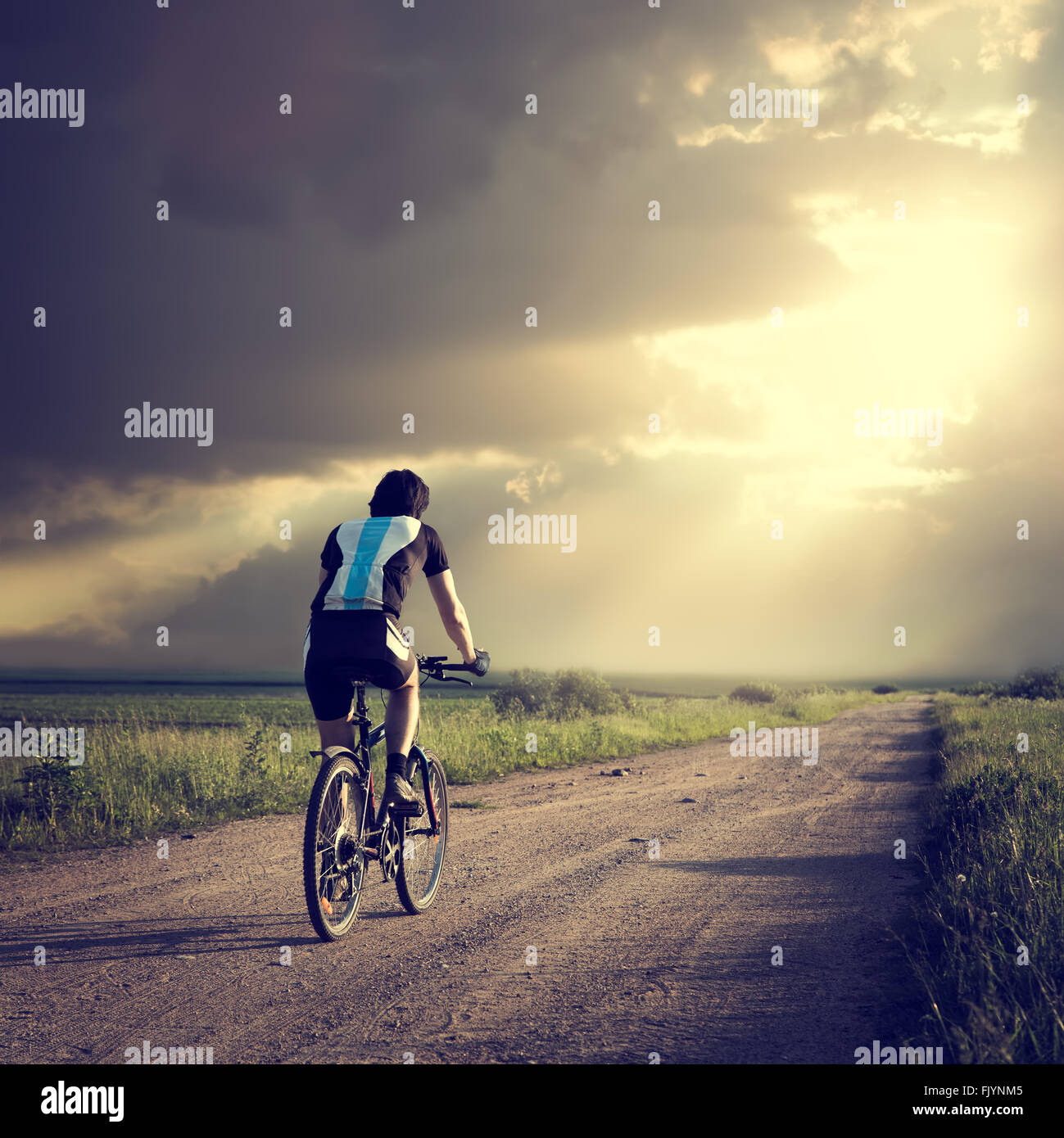 Epic Photo of Cyclist on Dramatic Sky Background Stock Photo - Alamy