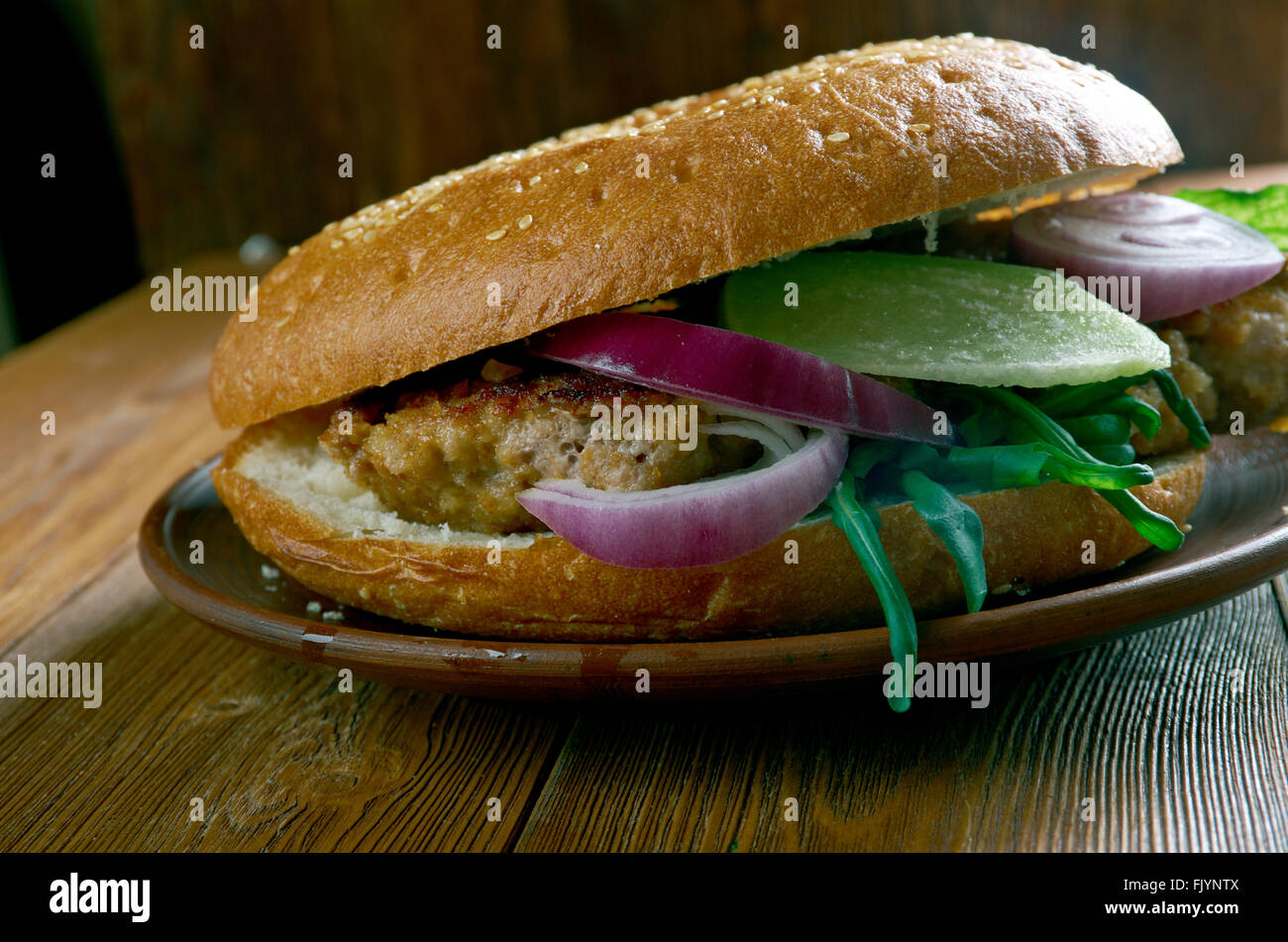 Balkan Burger with lettuce served .close up Stock Photo - Alamy
