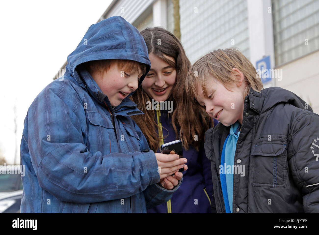 children playing with their smartphones Stock Photo - Alamy