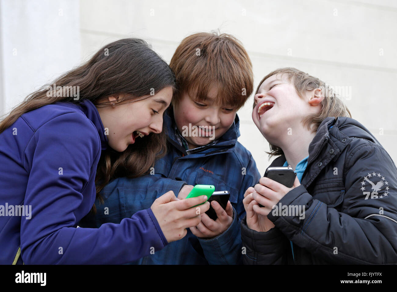 children playing with their smartphones Stock Photo - Alamy