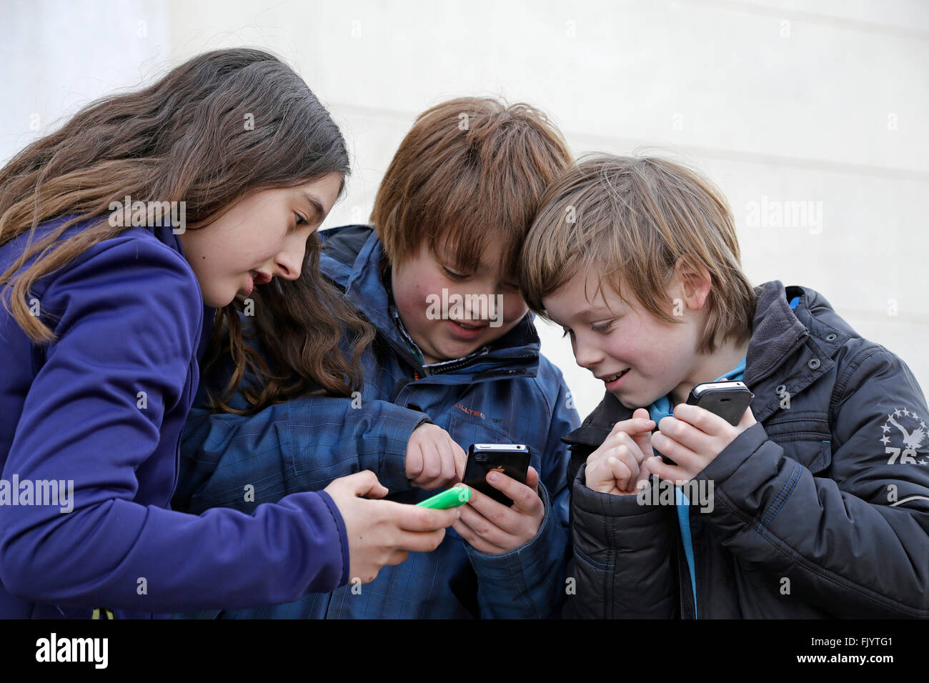 children playing with their smartphones Stock Photo - Alamy