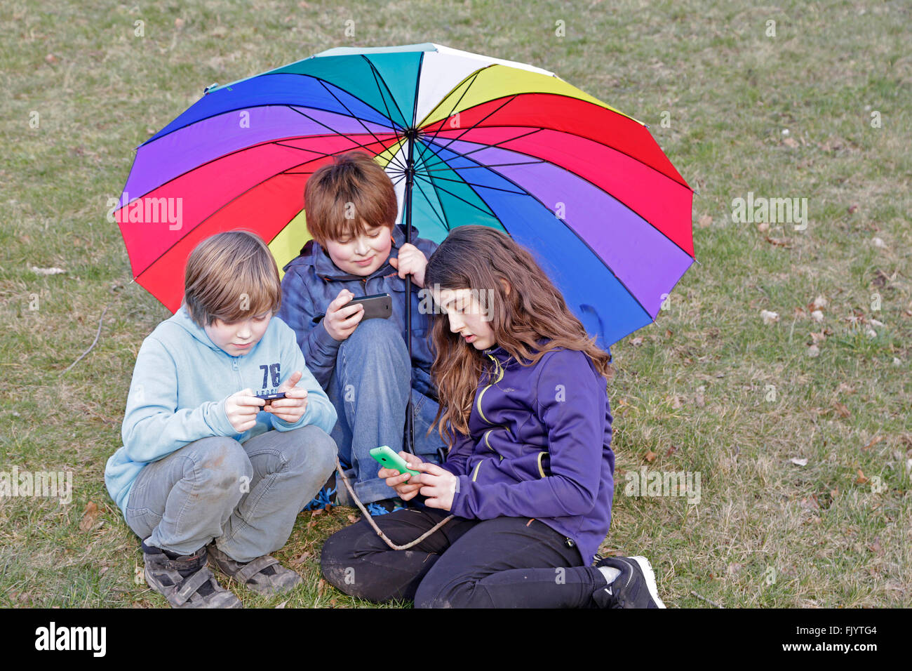 children playing with their smartphones Stock Photo - Alamy