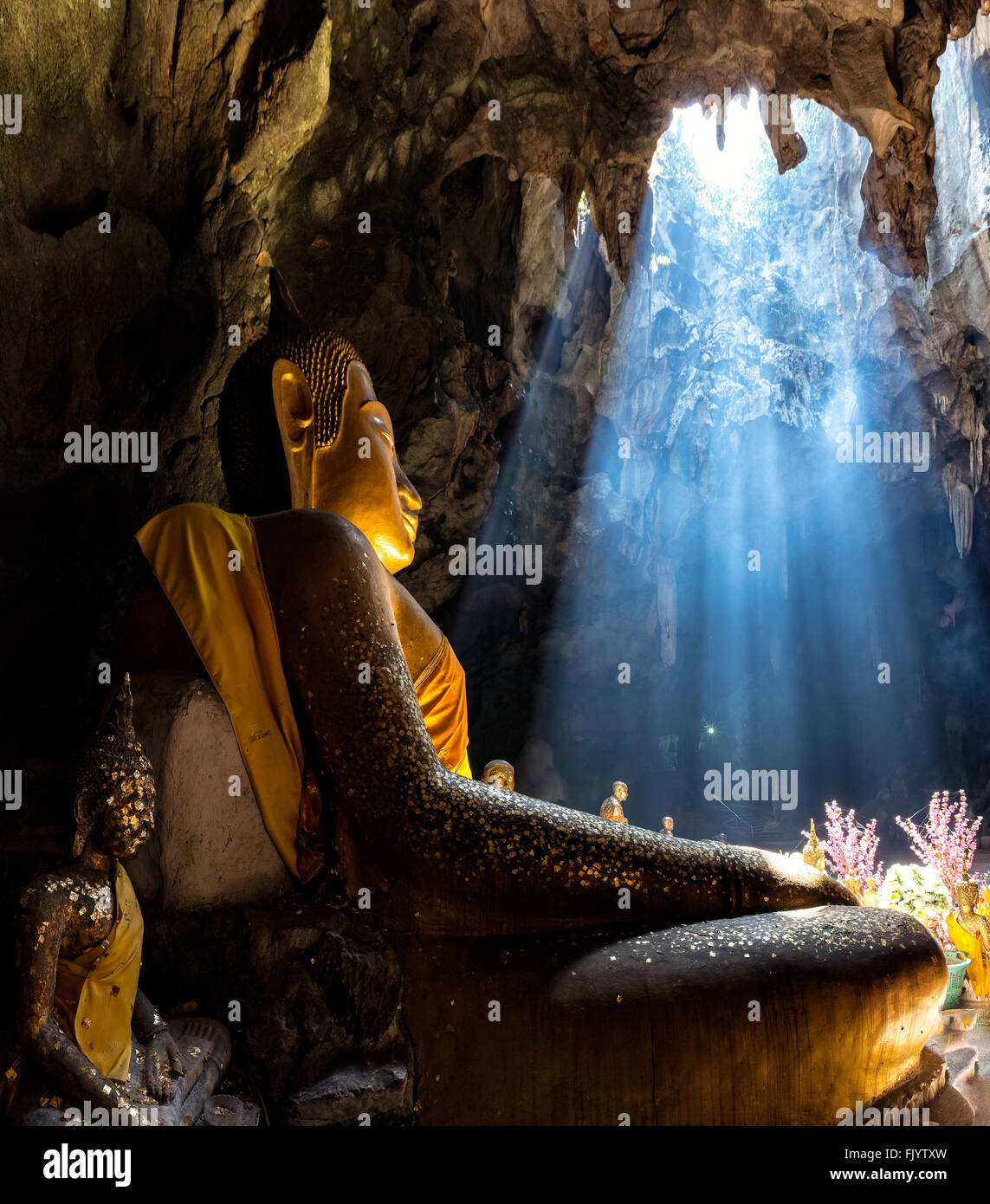 Amazing Buddhism with the ray of light in the cave Stock Photo - Alamy