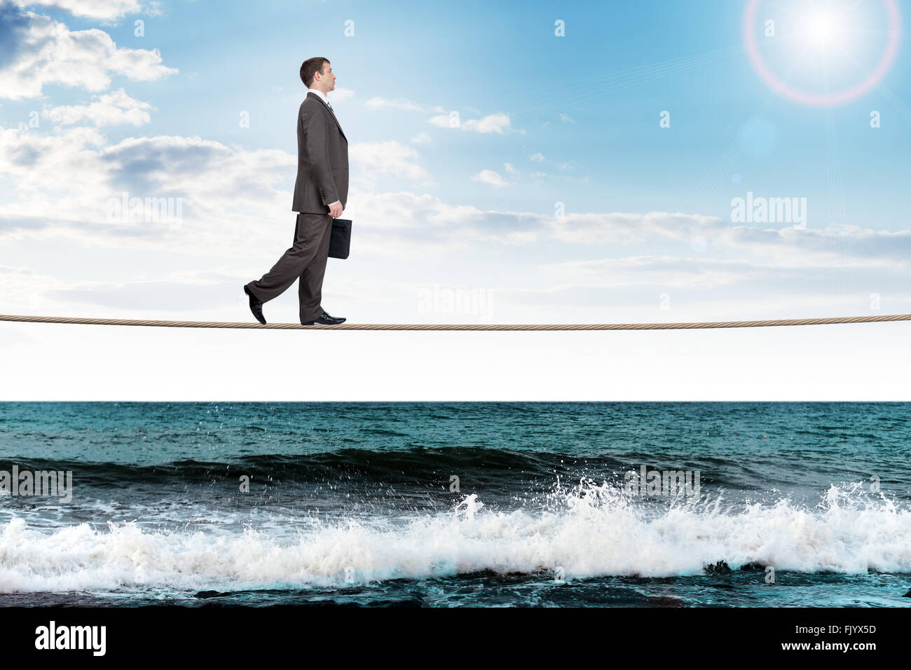 Businessman walking rope Stock Photo - Alamy