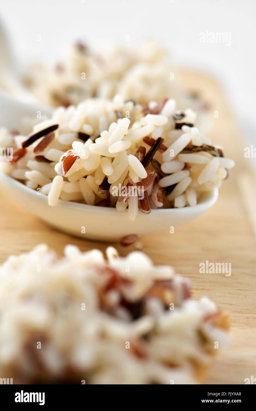 closeup of some small white ceramic bowls with cooked wild rice on a ...