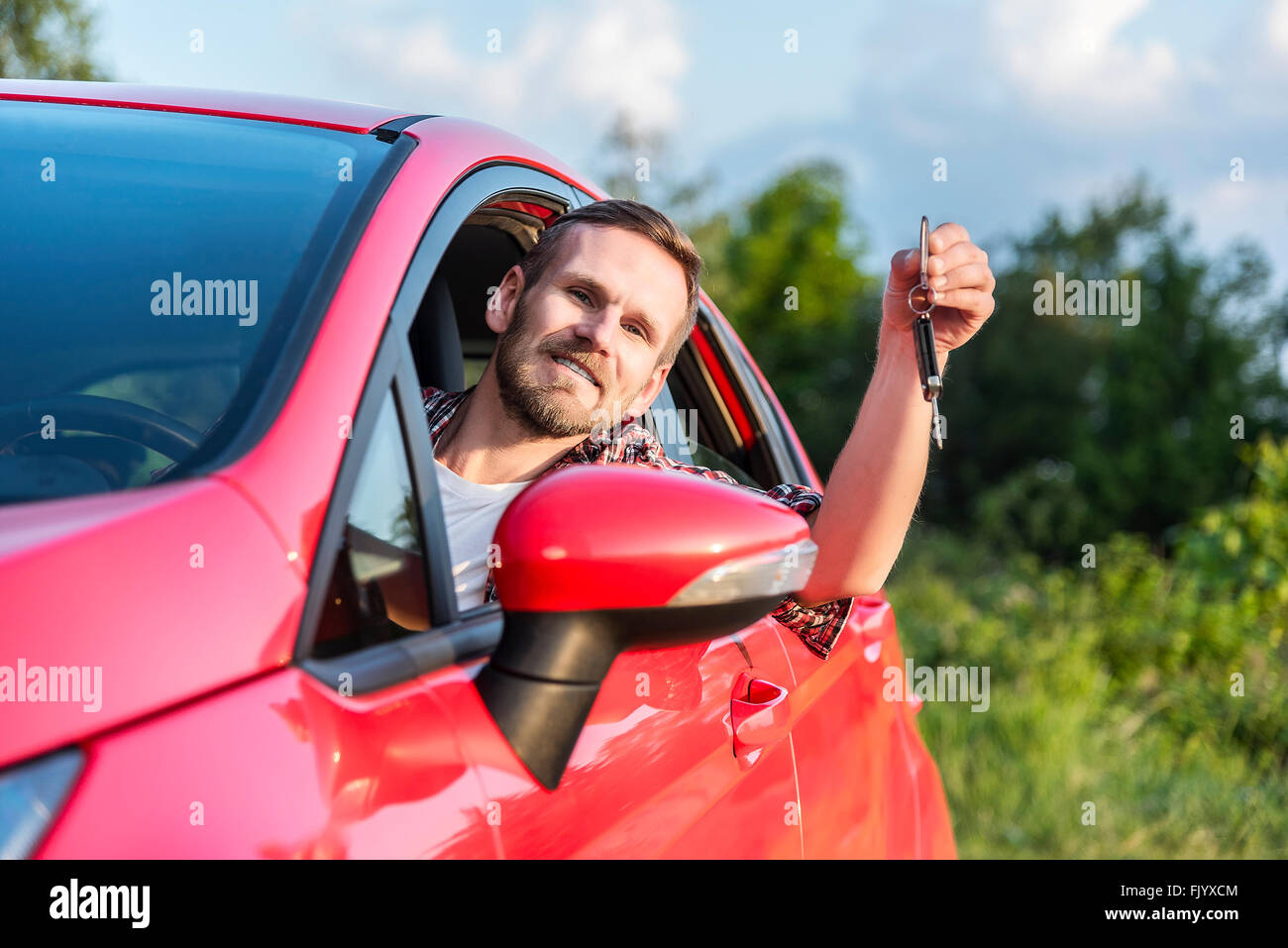 Man Sitting In A Car Showing New Car Key Stock Photo - Alamy