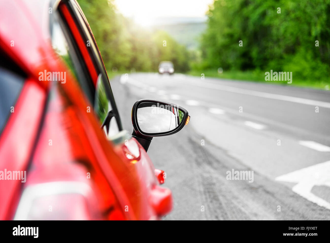 Red car on the road Stock Photo - Alamy
