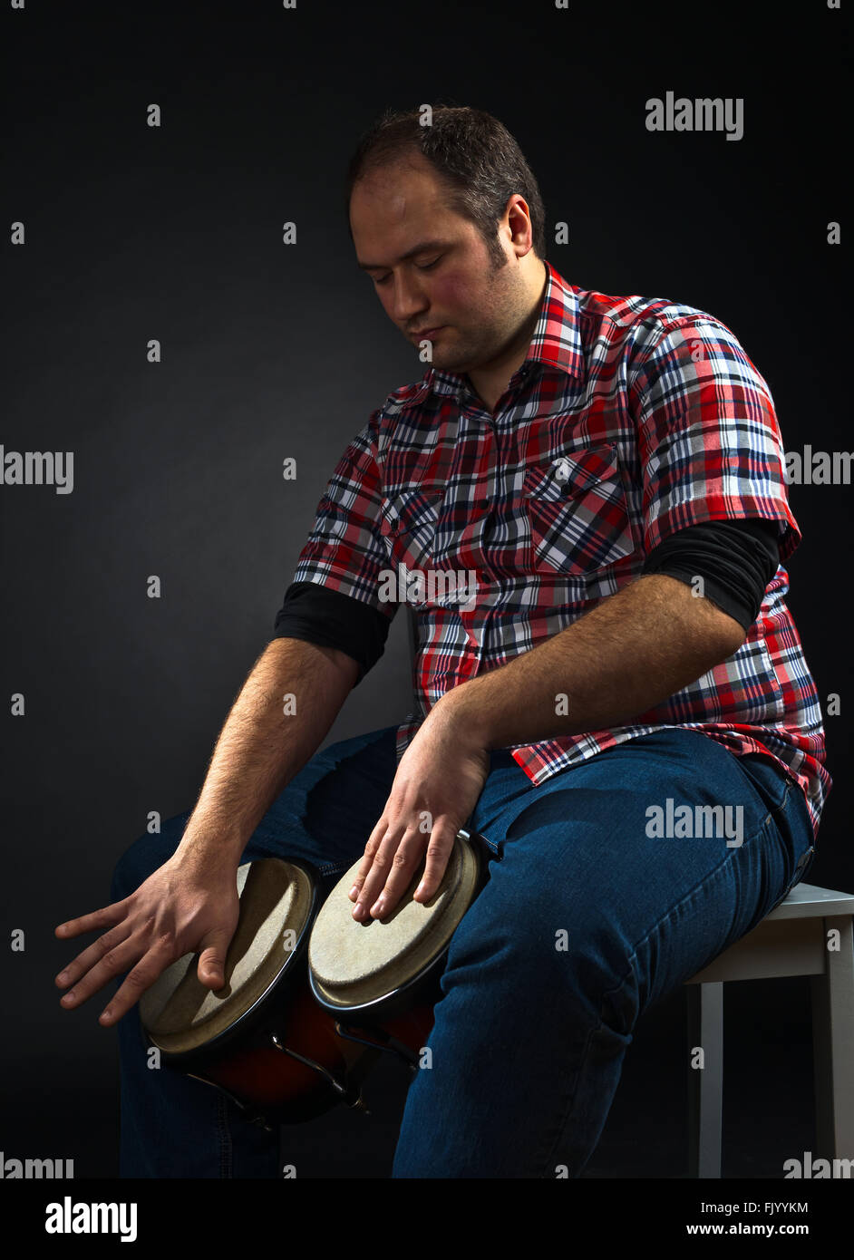 portrait of musician with bongo , studio shot Stock Photo - Alamy